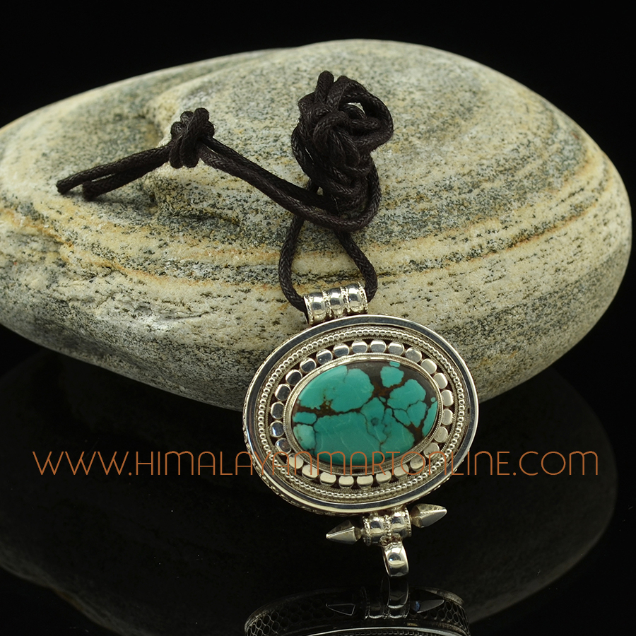 Turquoise Stone Silver Pendant or Ghau are used as jewelry or personal ...