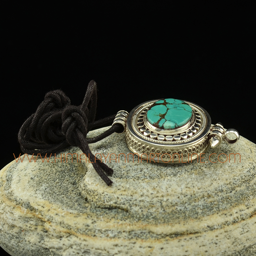 Turquoise Stone Silver Pendant or Ghau are used as jewelry or personal ...